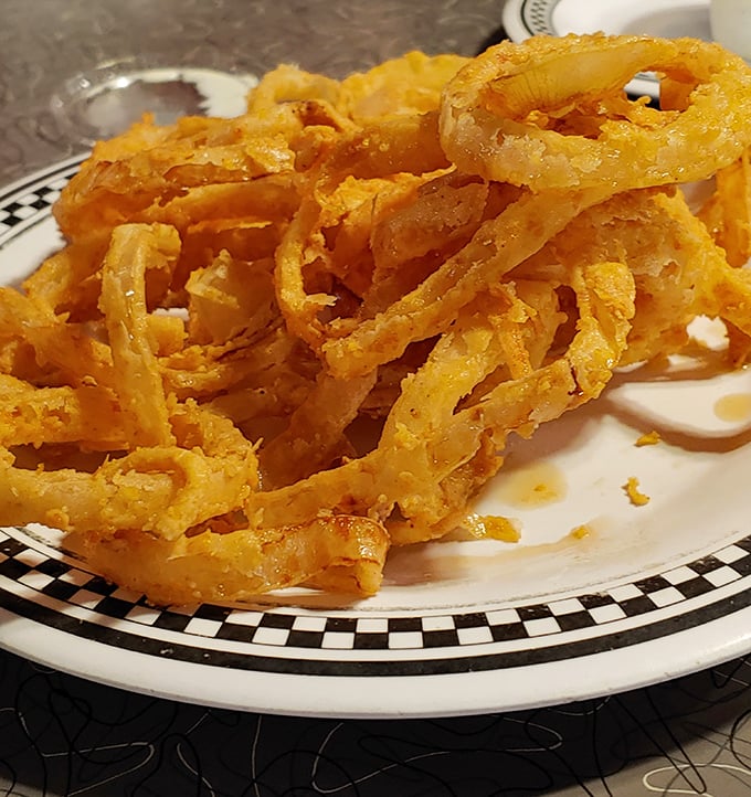 These onion rings aren't just fried – they're transformed into golden halos of crispy perfection that make you forget vegetables were ever healthy.