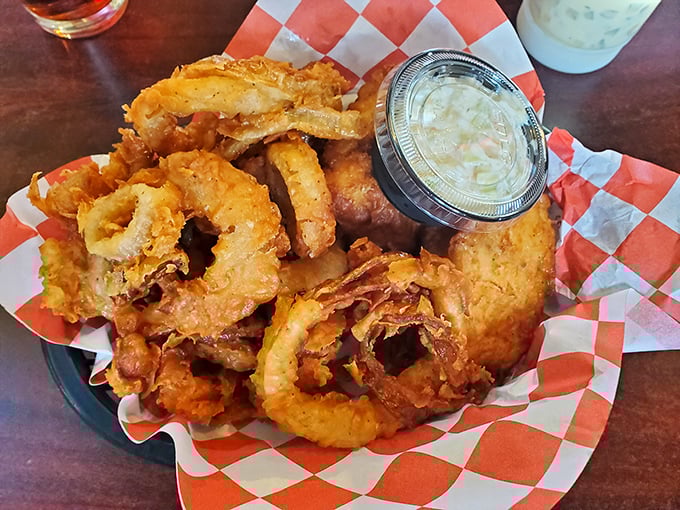 These aren't just any fried seafood bites &ndash; they're crispy little flavor bombs served with dipping sauce on a red-checkered paper that screams "this place knows what it's doing."