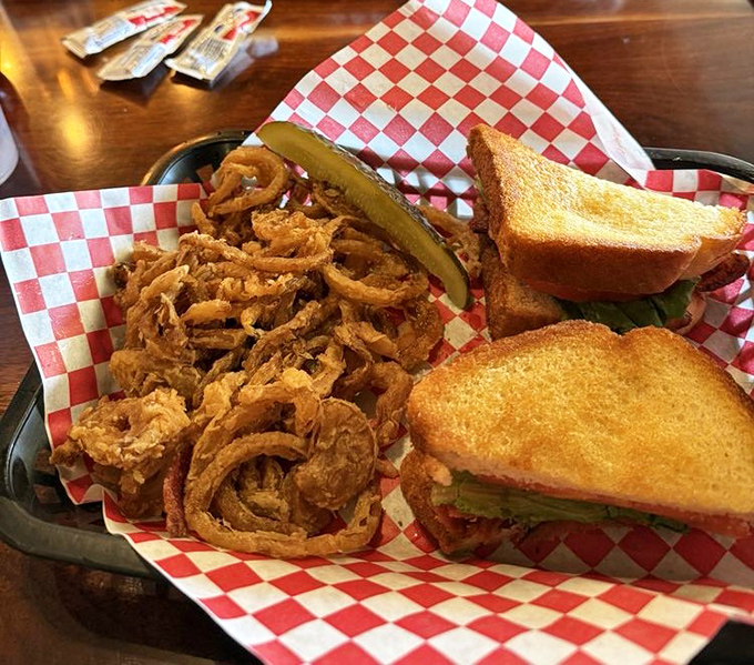 A sandwich flanked by a mountain of crispy onion rings. This is what happens when simple food is done right&mdash;no fancy tricks needed.