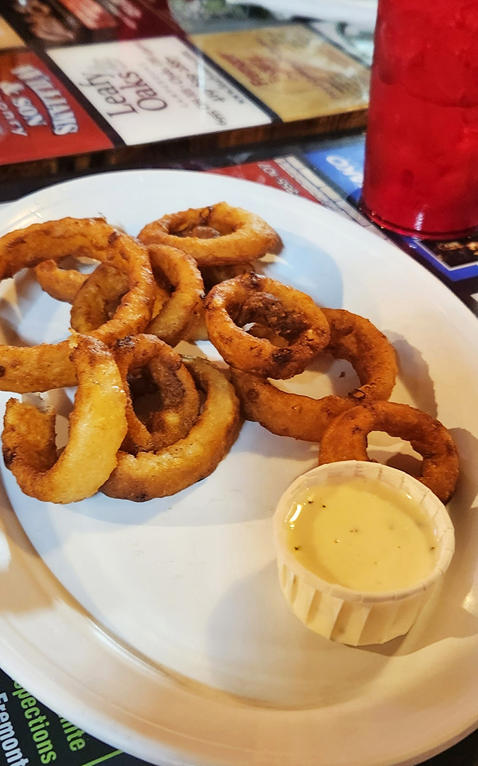 These aren't just onion rings&mdash;they're crispy golden halos of happiness. The perfect supporting act to the main fish attraction.