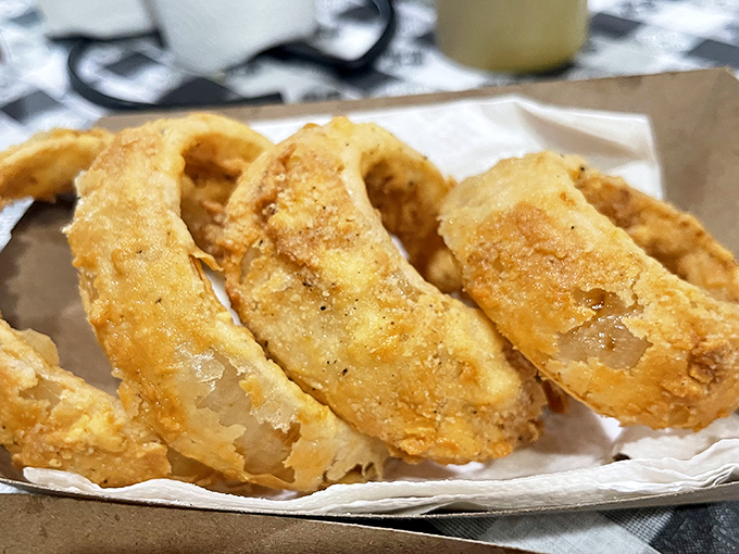 Golden-fried onion rings that shatter with each bite &ndash; the perfect crunchy counterpoint to the tender, saucy barbecue they accompany.
