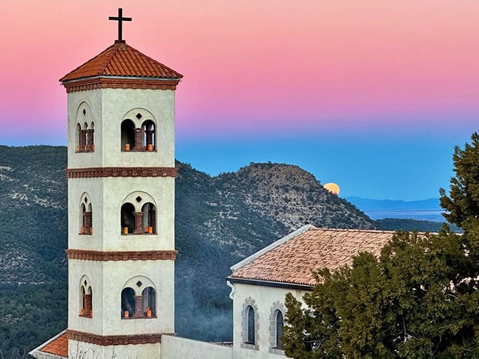 Our Lady of Guadalupe Monastery's bell tower reaches skyward against a sunset that looks like nature's own watercolor masterpiece.