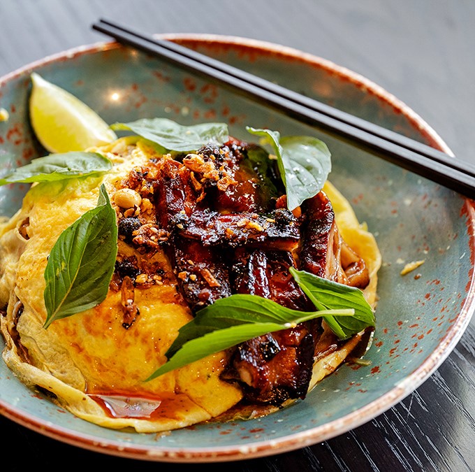 Not your college dorm noodles! This Not Pad Thai cradles a perfect egg amid glazed pork and fresh herbs. Chopsticks required, napkins recommended.