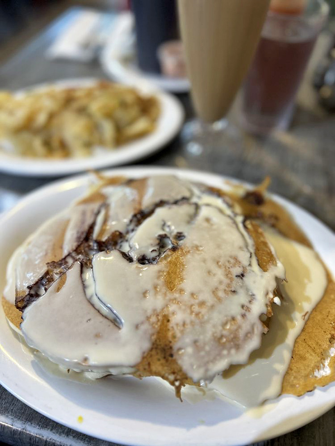 These pancakes aren't just topped with cream—they're smothered in a dairy avalanche that would make a Vermont farmer blush with pride.
