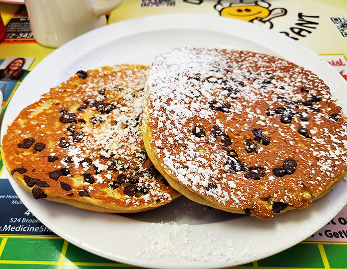 Chocolate chip pancakes dusted with powdered sugar &ndash; because sometimes breakfast should feel like you're getting away with something deliciously naughty before noon.