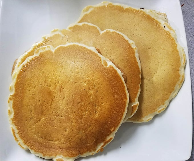 Golden pancakes with the perfect crisp edge—these fluffy discs aren't just breakfast, they're edible sunshine on a plate.