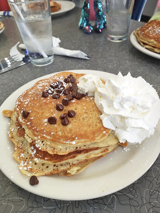 Chocolate chip pancakes with a mountain of whipped cream&mdash;because sometimes breakfast should feel like you're getting away with something.