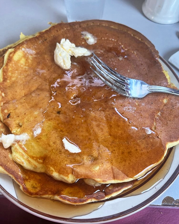 These pancakes aren't just golden brown&mdash;they're 24-karat breakfast gold. That melting butter creating its own little maple syrup swimming pool is pure morning poetry.