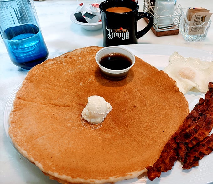 A pancake so perfectly golden and massive it deserves its own zip code. The butter melts into a puddle of breakfast bliss.