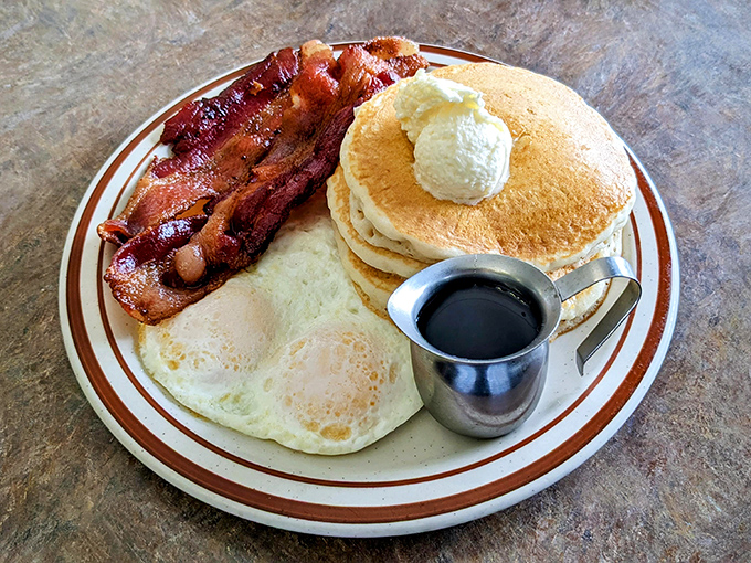 Breakfast nirvana: golden pancakes, perfectly cooked eggs, and bacon that should win some kind of lifetime achievement award.