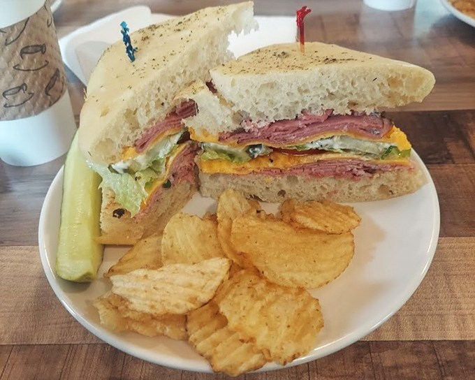 This isn't just a sandwich; it's architecture with mustard. Layers of pastrami, cheese and veggies create the skyscraper of lunch options, with chips as the foundation.