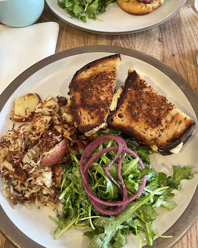 The humble patty melt gets the respect it deserves—perfectly griddled bread, melty cheese, and those hash browns that make you question all other potato preparations.