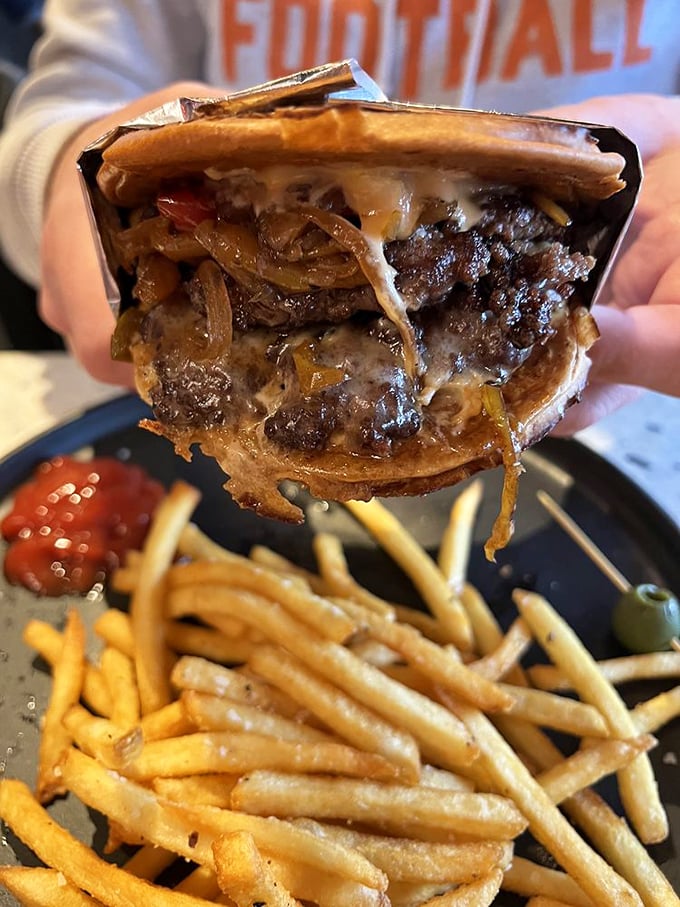 This isn't just a patty melt—it's a towering achievement of beef, melted cheese, and caramelized onions that requires both hands and zero shame.