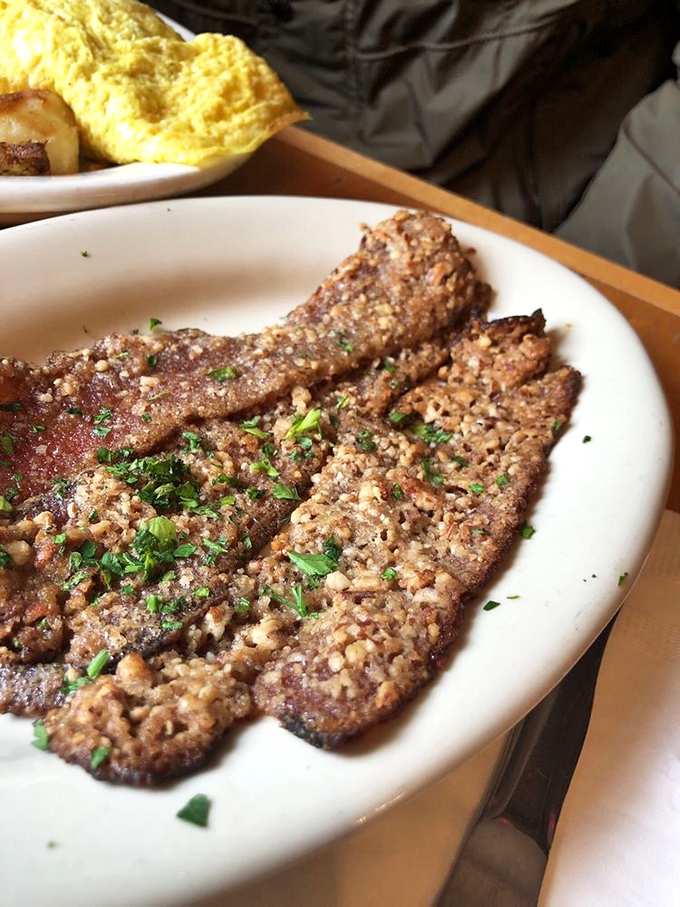 Pecan-crusted bacon that's been elevated from mere breakfast side to main attraction &ndash; proof that sometimes the supporting actors steal the show.