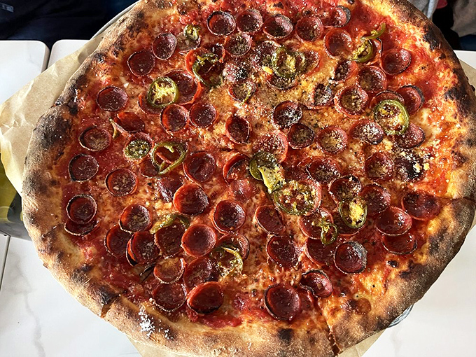 The Classic Pep pizza arrives like a work of art – perfectly charred crust, vibrant sauce, and pepperoni cups that have crisped into little flavor reservoirs.