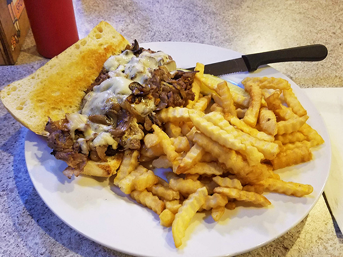 A Philly cheesesteak that doesn't apologize for its abundance. Those crinkle-cut fries aren't just a side&mdash;they're part of the main event.