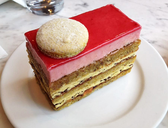 This isn't just cake – it's architecture. The glossy red top layer signals "danger" to your diet but "paradise" to your soul.