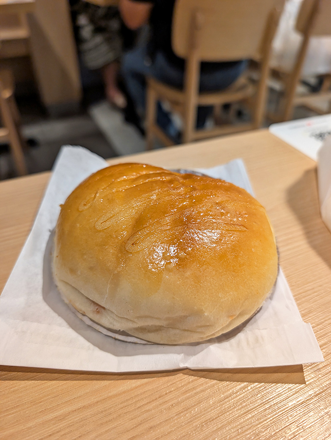 The golden-brown crown of this pork bun could make royalty jealous. One bite through that glossy exterior reveals a world of savory delight.