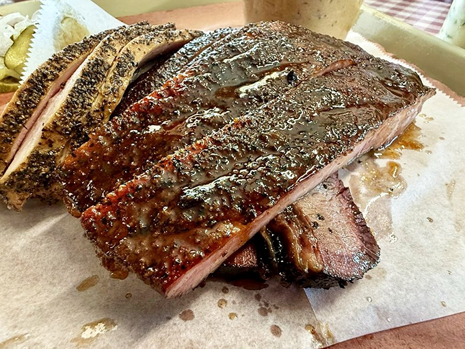 These ribs have the perfect bark-to-meat ratio, glistening with a glaze that would make even vegetarians question their life choices.
