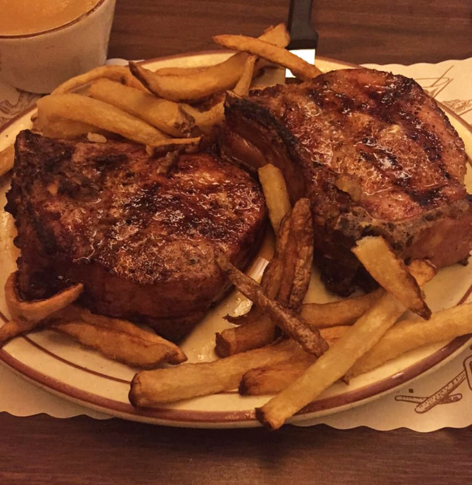 Pork chops so magnificent they deserve their own ZIP code. That beautiful char speaks of patience, skill, and the transformative power of red oak.