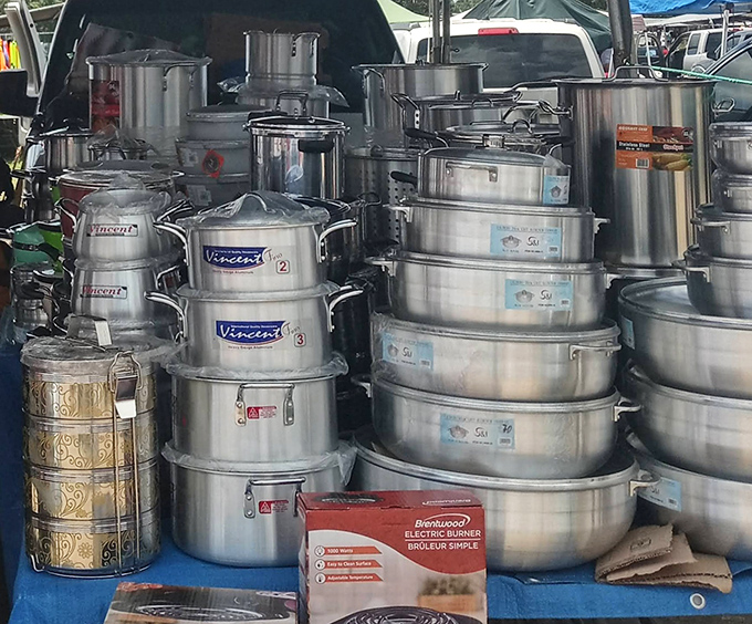 Stainless steel cookware stacked higher than your cooking ambitions, ready to transform your kitchen into something almost professional-looking.