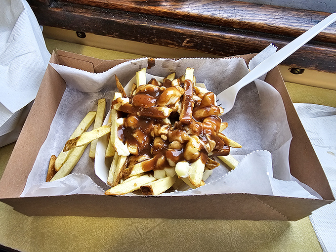 Poutine paradise! Golden fries swimming in gravy and cheese curds—a Canadian classic that found its spiritual home in New Hampshire.