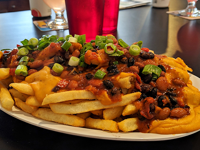 Loaded fries topped with barbecue goodness and green onions: basically a food pyramid made entirely of happiness and cheese.