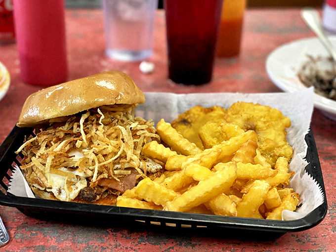This isn't just a sandwich; it's architecture. Crispy potato strings creating the perfect textural roof over seasoned pulled pork.