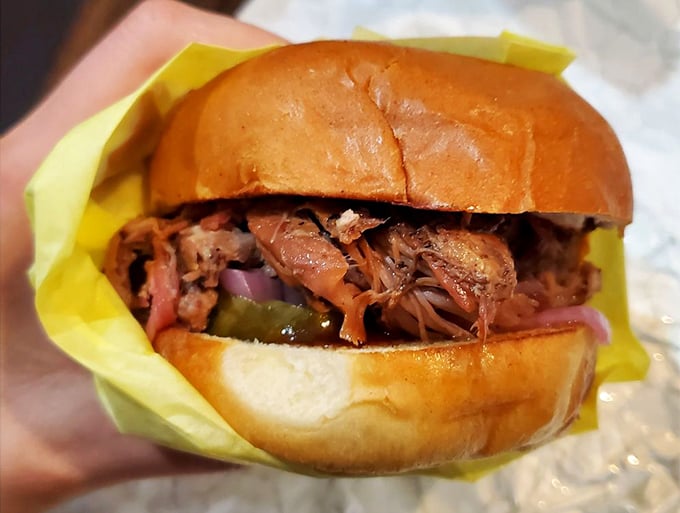 A pulled pork sandwich that puts ordinary lunch options to shame. The pickled onions and jalape&ntilde;os cut through the richness like witty banter at a dinner party.