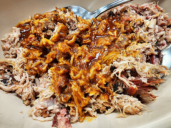 Pulled pork so tender it practically surrendered to the fork, glistening with that perfect balance of smoke and sauce.