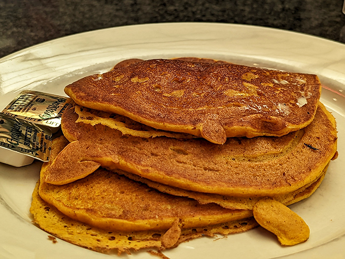 These pumpkin pancakes aren't just breakfast&mdash;they're an autumn festival on a plate. Cinnamon-kissed discs of joy waiting for maple baptism.
