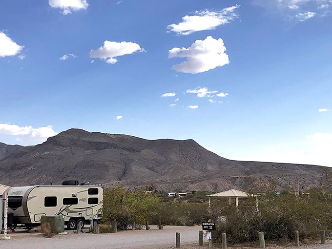 RV camping with a view that beats any five-star hotel wallpaper. Those mountains aren't just scenery—they're roommates.