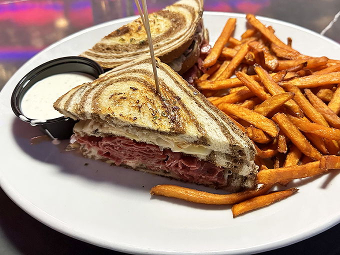 The Reuben sandwich here isn't messing around &ndash; stacked higher than some Vegas hotel towers and flanked by sweet potato fries that could convert a carb-avoider.