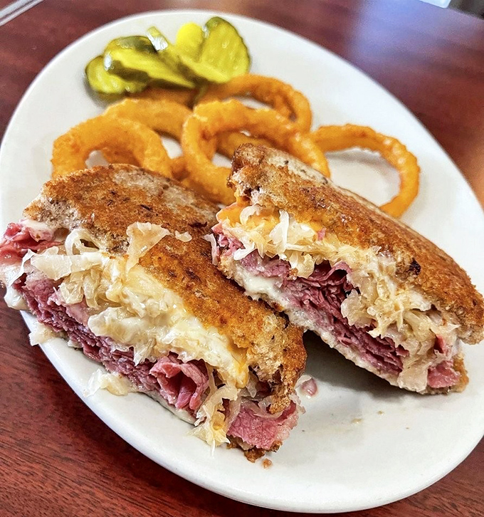 The Reuben sandwich&mdash;where corned beef, sauerkraut, and Swiss cheese perform a perfectly choreographed dance on grilled rye. Those onion rings deserve their own standing ovation.