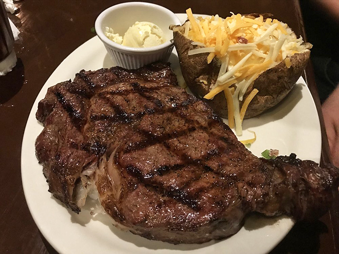 Grill marks aren't just decoration—they're a promise kept. This ribeye with loaded baked potato is the definition of "worth it."