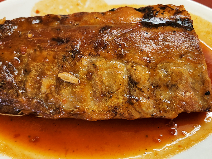 These ribs aren't just falling off the bone&mdash;they're practically volunteering to jump onto your fork. The sauce glistens like a barbecue sunset.