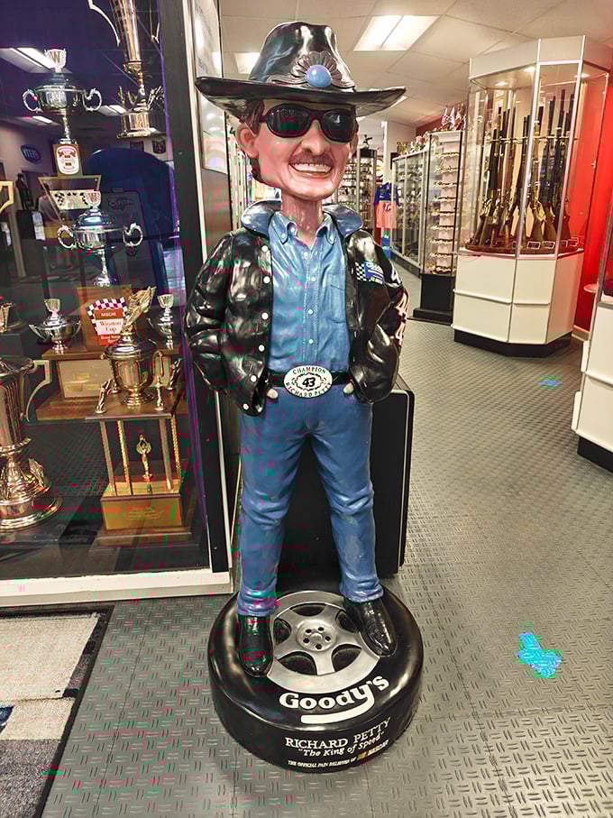 The King stands guard! This playful statue captures the signature sunglasses, cowboy hat, and confident stance that made him instantly recognizable.