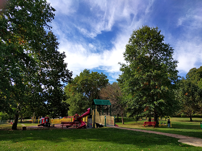 This neighborhood park offers a perfect respite from urban life, where towering trees stand guard over playground adventures and family picnics.