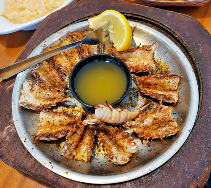 Rock shrimp arranged like a sunburst around liquid gold butter &ndash; nature's perfect food delivery system.