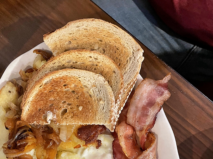 Breakfast of champions: perfectly toasted rye, crispy bacon, and eggs. The holy trinity of morning satisfaction that never disappoints.