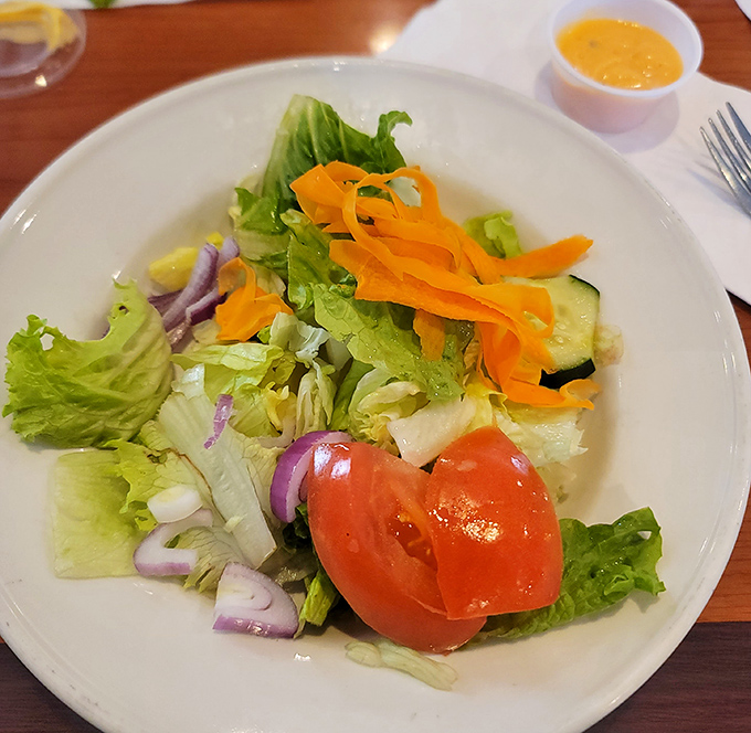 A garden salad that's actually worth ordering, dressed up with ribbons of carrot like nature's confetti.