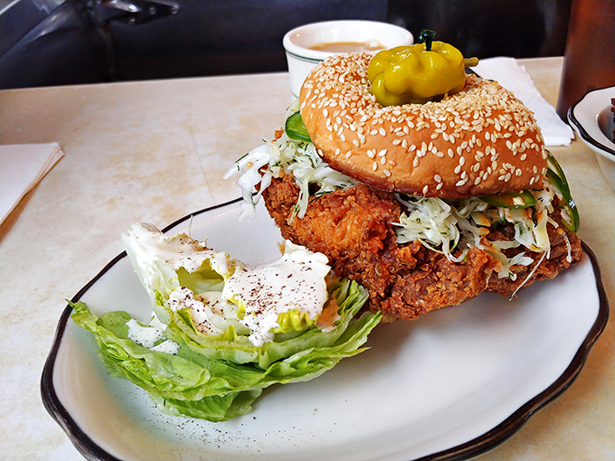 Not just a sandwich, but an architectural marvel of crispy chicken, fresh slaw, and that perfectly toasted sesame bun. Worth every napkin.