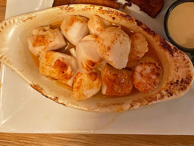 These scallops aren't just cooked&mdash;they're respected. Perfectly seared and swimming in butter, they're the ocean's candy served in a dish that means business.