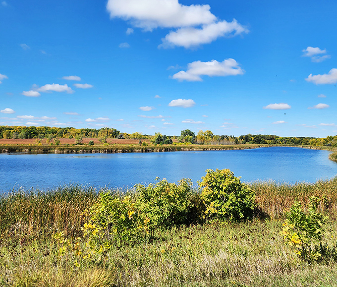 The lake reflects clouds with such perfect symmetry, it's as if Mother Nature is showing off her Photoshop skills without the monthly subscription fee.