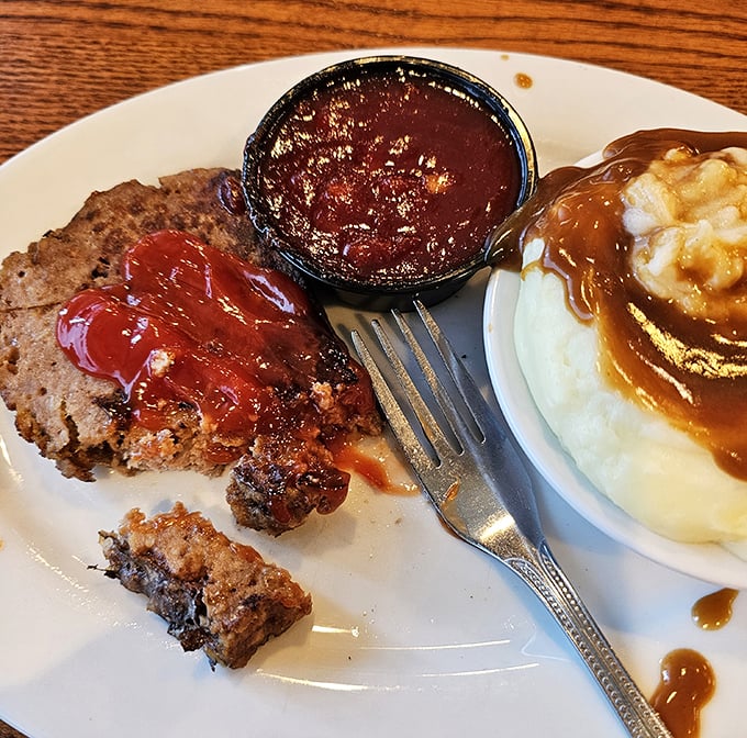 Meatloaf with a side of mashed potatoes and gravy—comfort food that doesn't need a fancy introduction, just a willing fork and an empty stomach.
