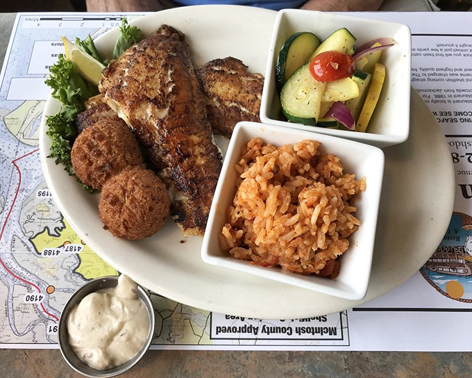 Blackened perfection meets colorful companions. This fish dish with rice and fresh vegetables proves simple preparations often yield the most satisfying results.