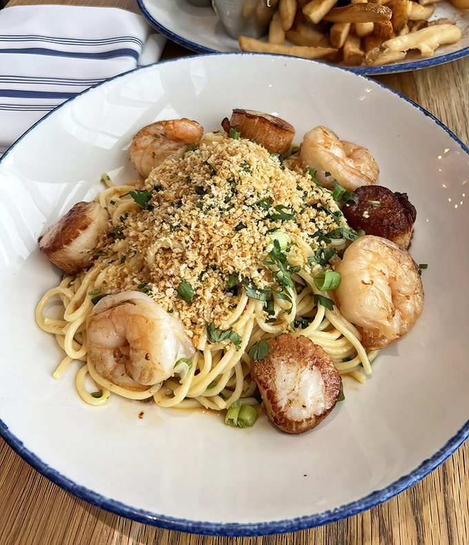 Scallops and shrimp circling pasta like they're protecting something precious&mdash;which, honestly, they are: your upcoming food happiness.