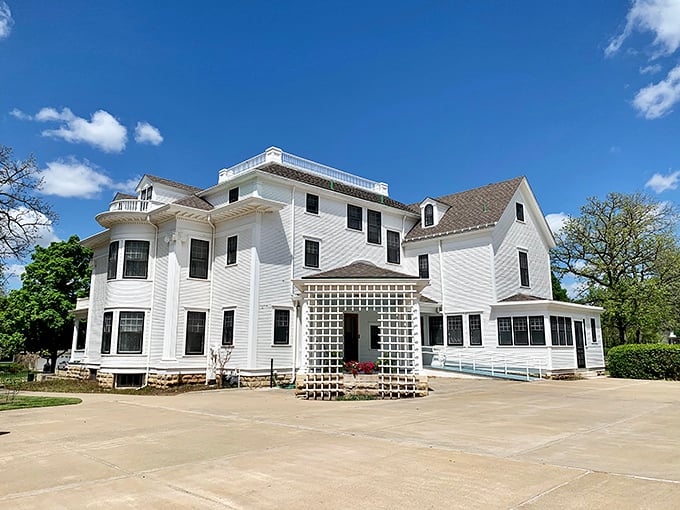 The Seelye Mansion stands pristine in white, its Victorian elegance a testament to the prosperity that followed Abilene's wild cattle town days.