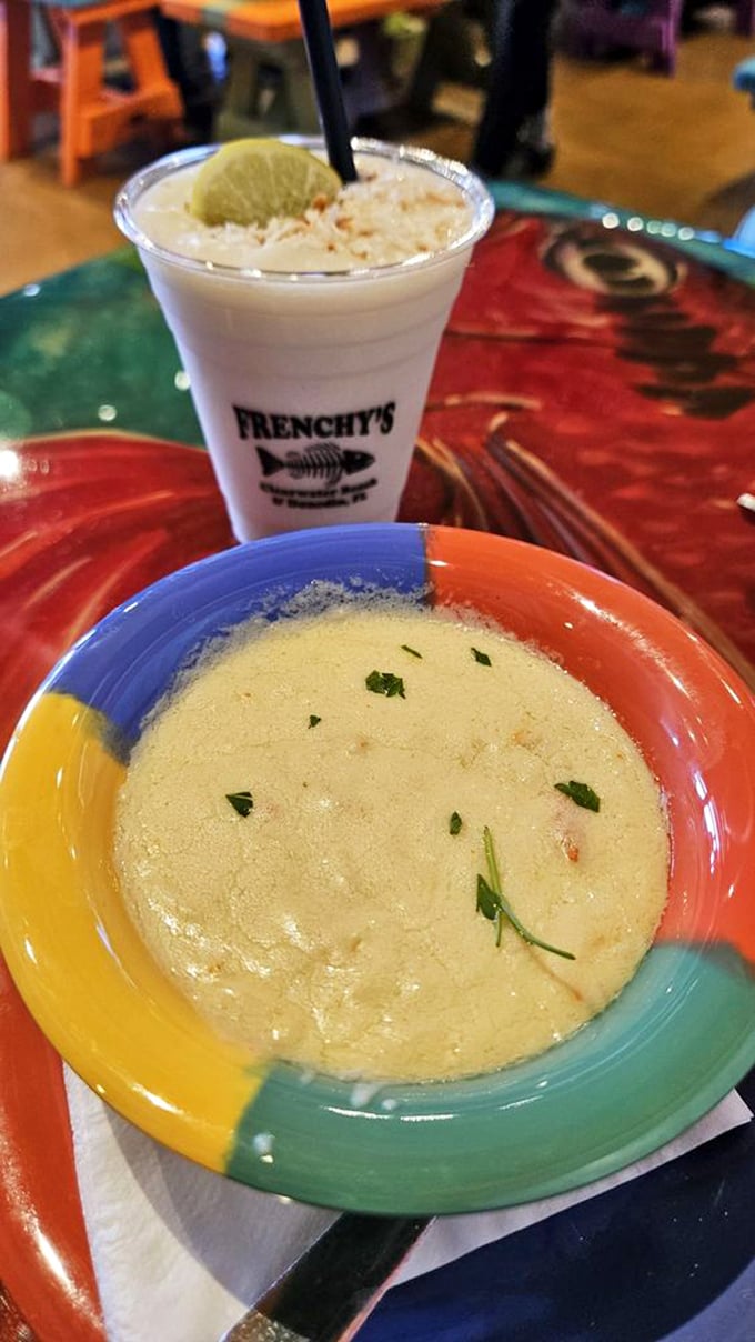 The She Crab Soup arrives like a warm, creamy hug in a colorful bowl, garnished with just enough green to pretend it's healthy.