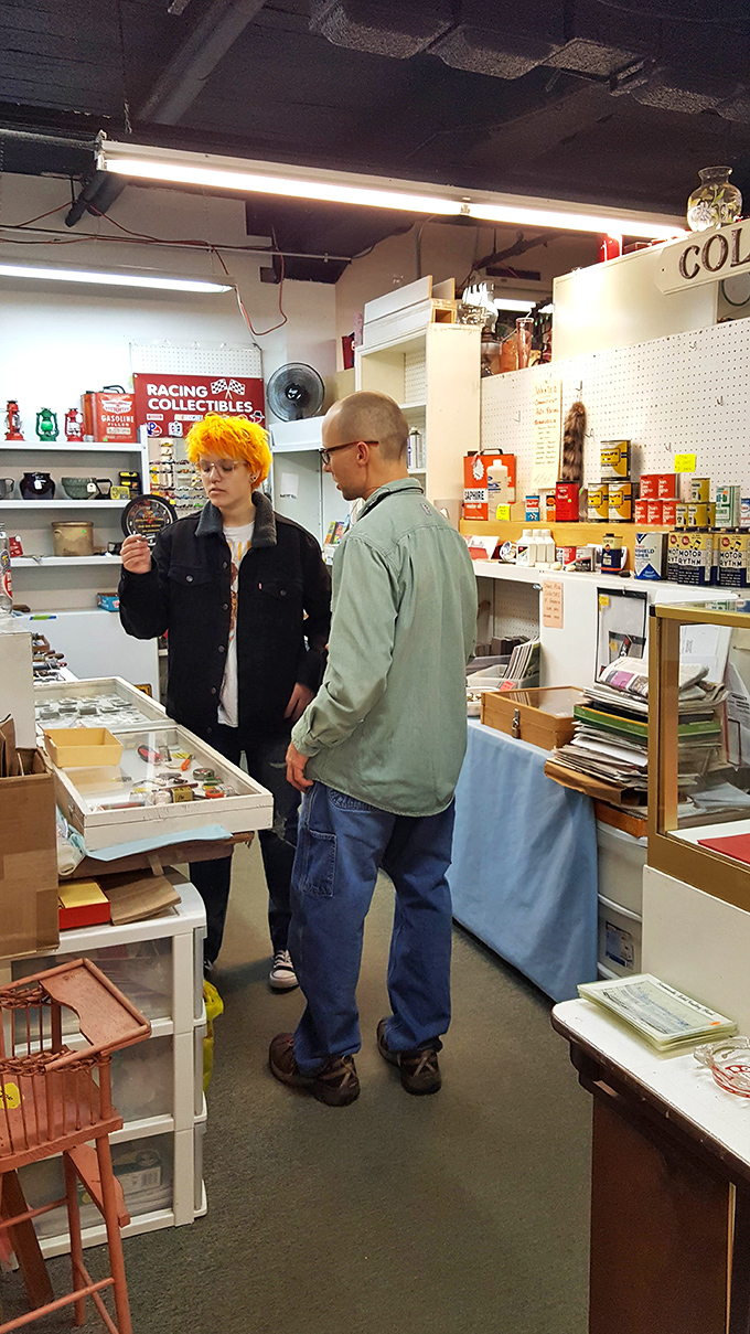 Young treasure hunters examine racing collectibles, proving that the thrill of the find transcends generational boundaries.